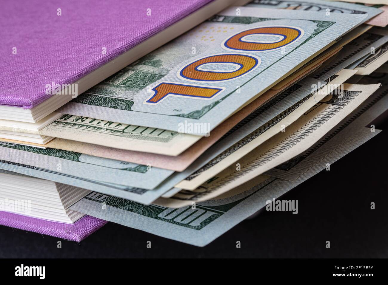 dollar banknotes in violet book Stock Photo - Alamy