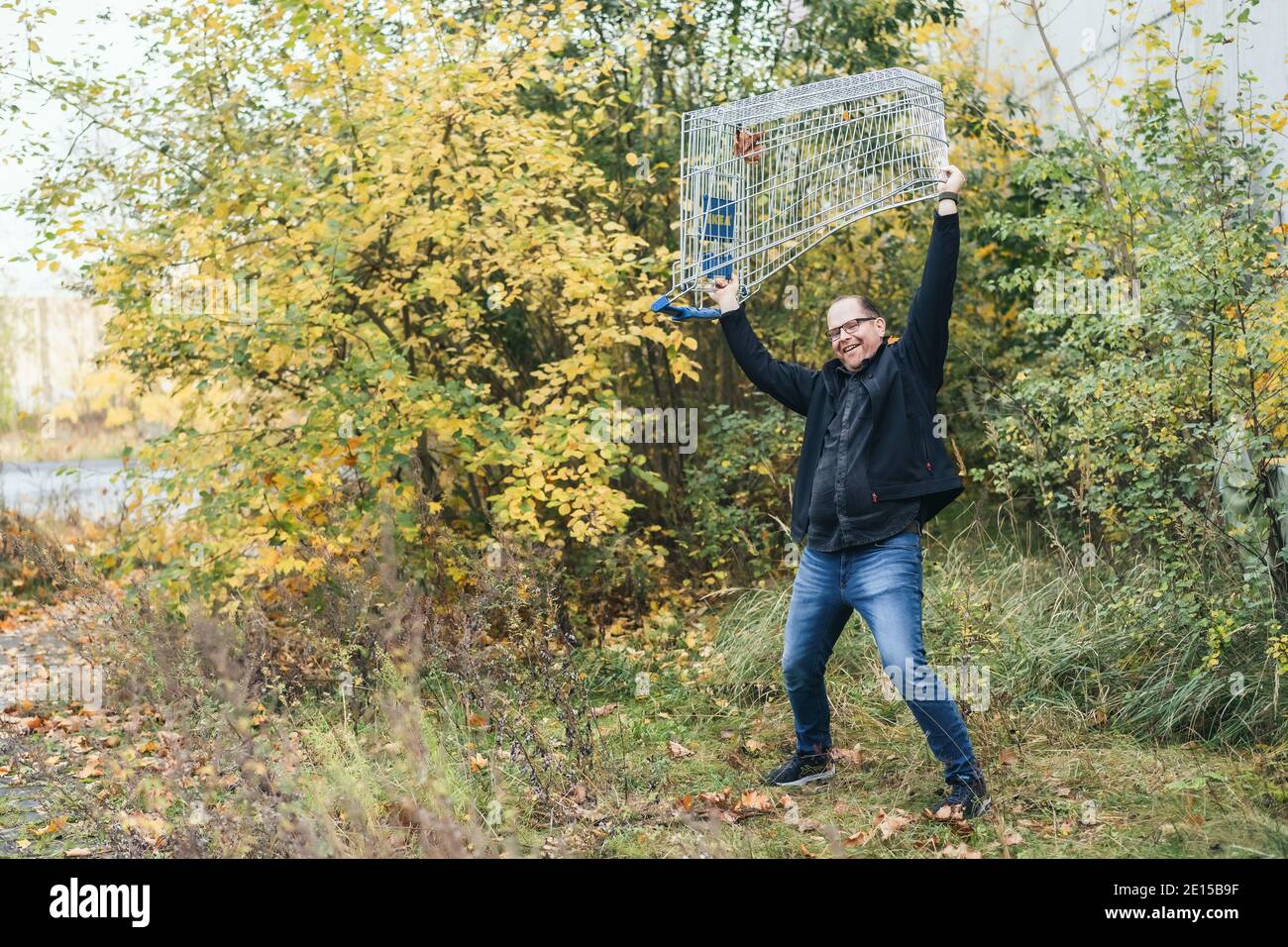 picture of a young man who lifts a shopping trolley over his head and ...