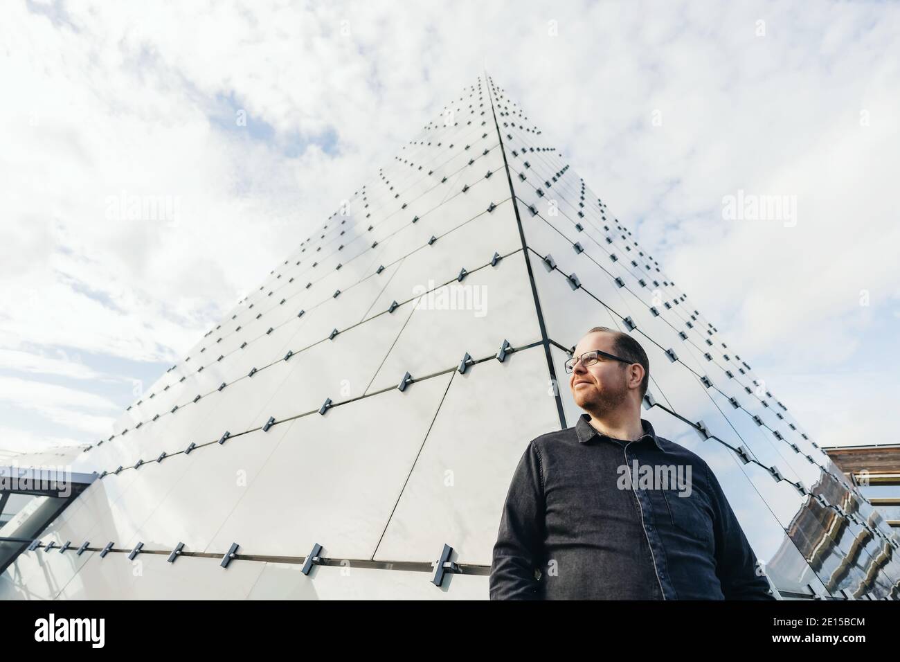 picture of a young business man in front of a pyramid building looking ...