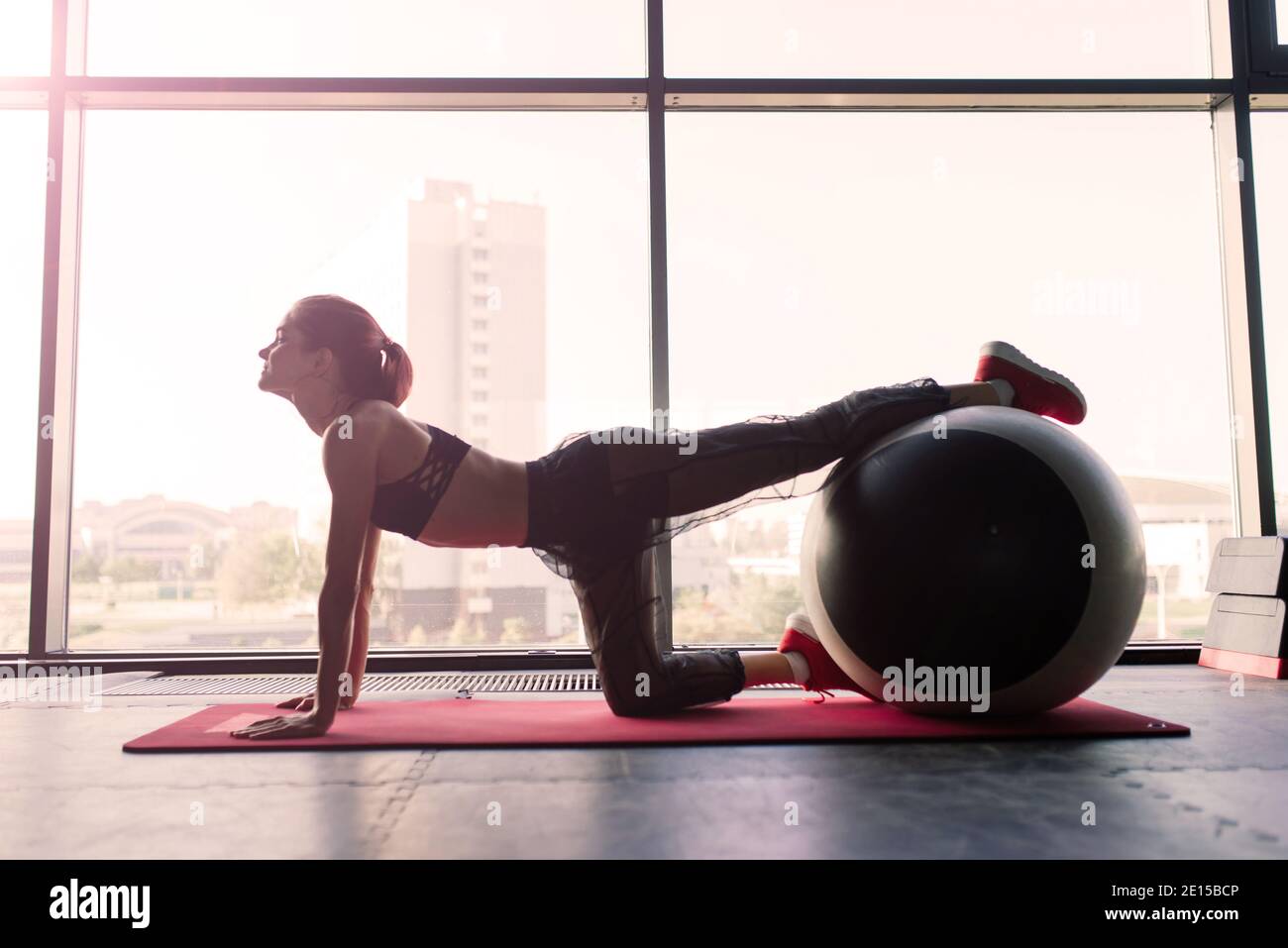 Shot of fitness woman on exercise mat. Female athlete lying on her back ...