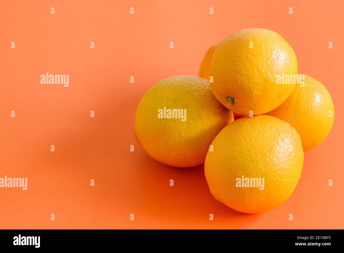 Group of fresh sweet oranges on the coral background. Fresh fruity ...