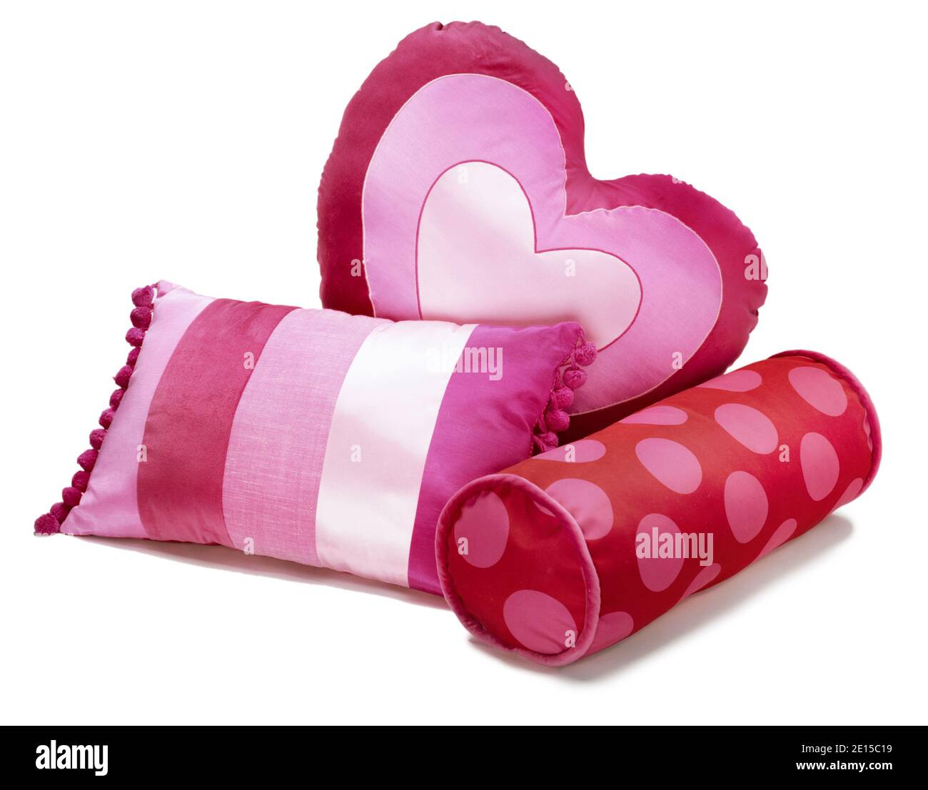 Pink and red decorative throw pillows photographed on a white ...