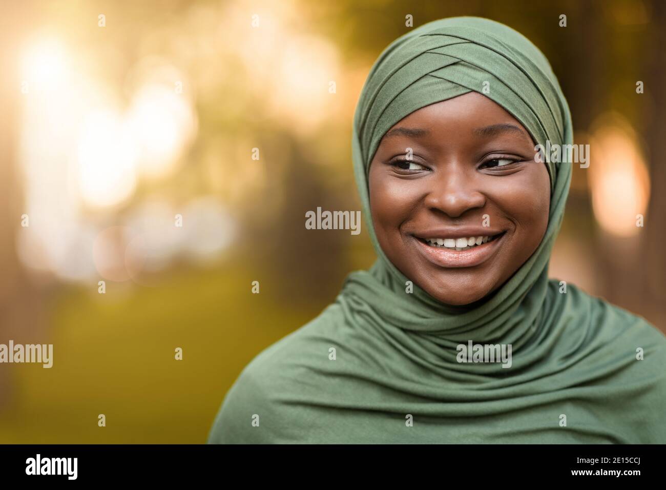 Beautiful Black Islamic Lady In Hijab Standing Outdoors And Looking ...