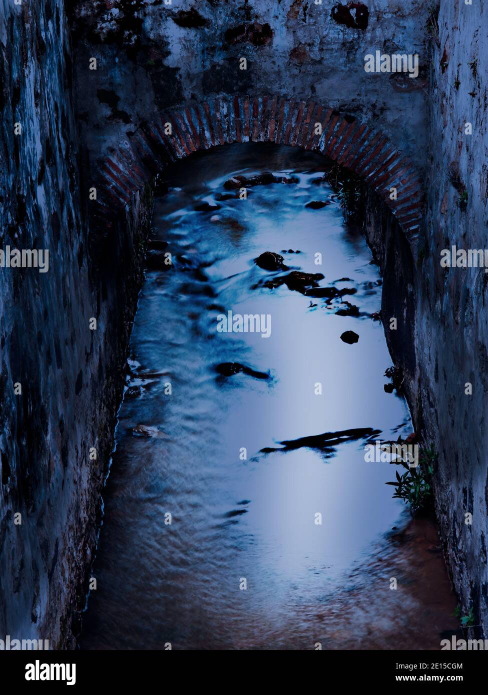 Sewer With Running Water At Night Stock Photo - Alamy
