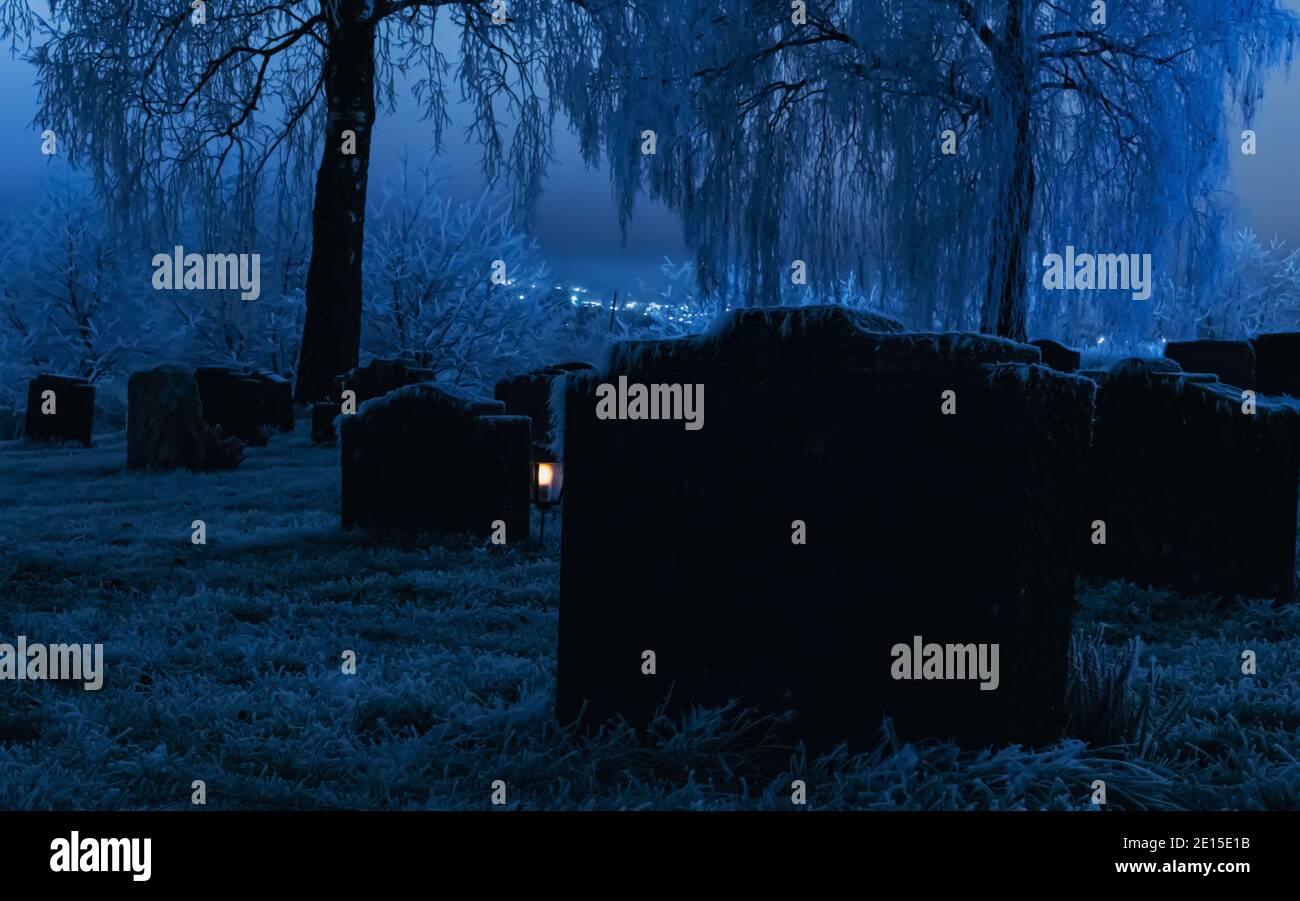 Tombstones in a frozen graveyard on a cold winters night Stock Photo ...