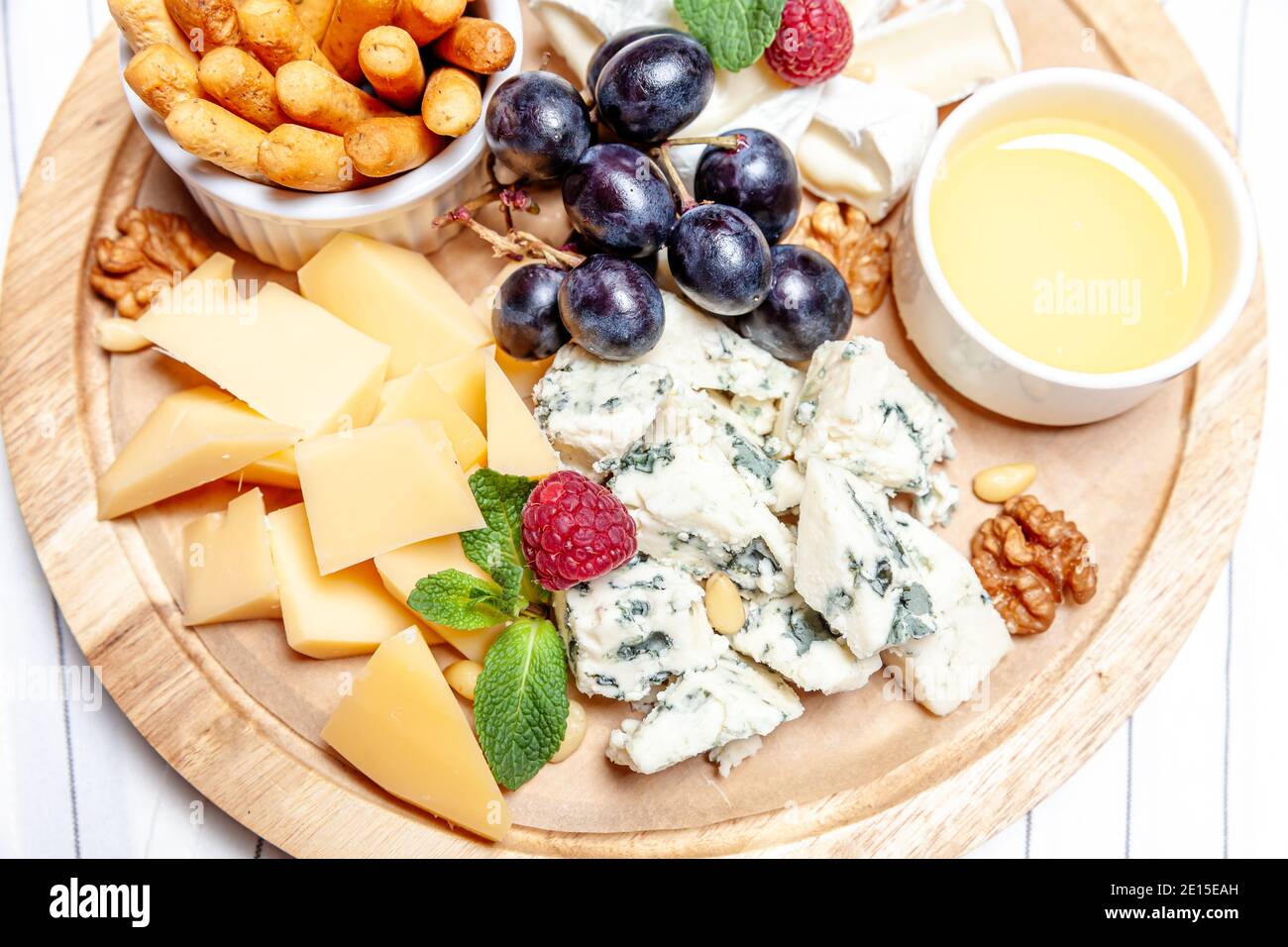 Board with different types of cheese. Cheeses mix set dor blu chedar ...