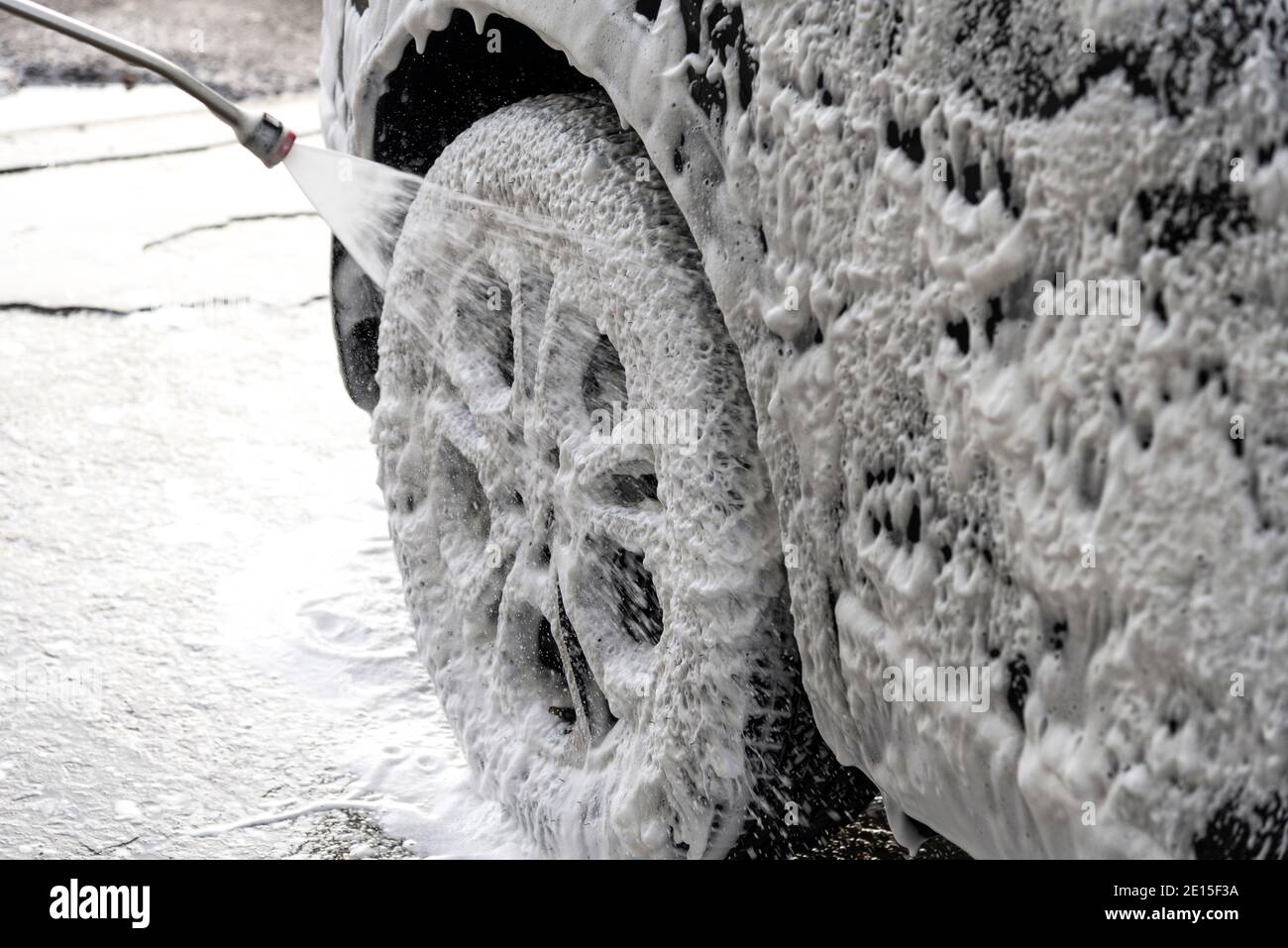 Car in foam. Car getting a wash with soap, car washing Stock Photo - Alamy