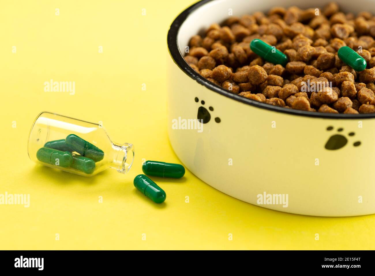 Animal food with tablets in a bowl. Vitamins for animals. Treating cats ...