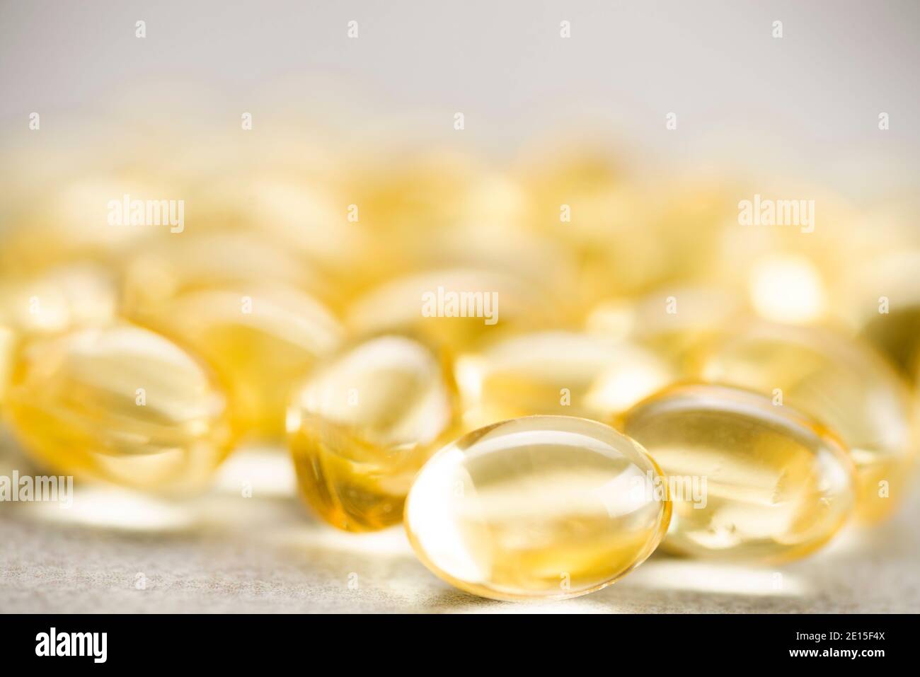 many yellow pills close-up, vitamins, dietary supplements Stock Photo ...