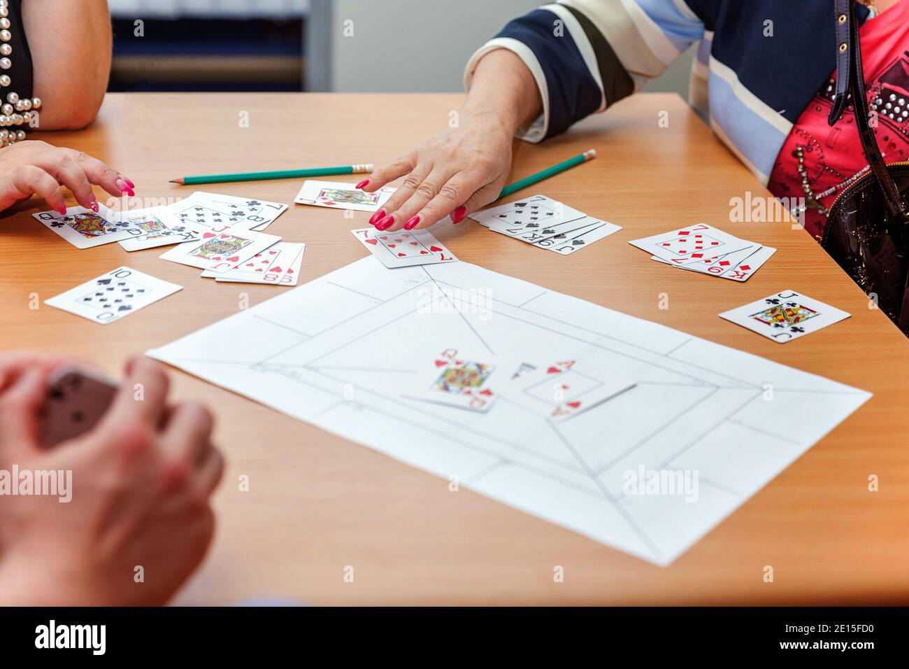 Cropped hands holding playing cards hi-res stock photography and images ...