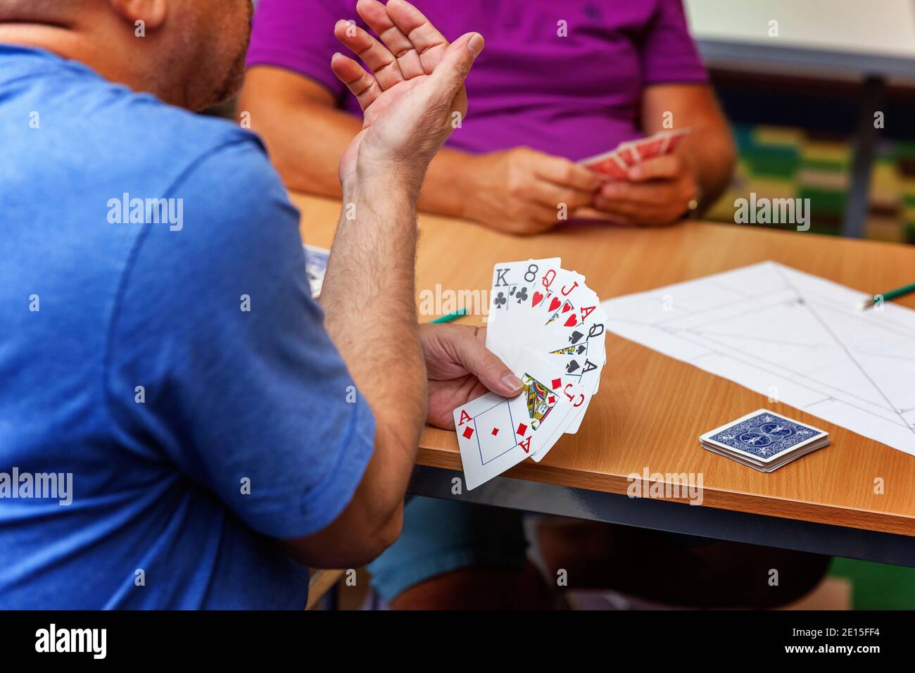 Cropped hands holding playing cards hi-res stock photography and images ...