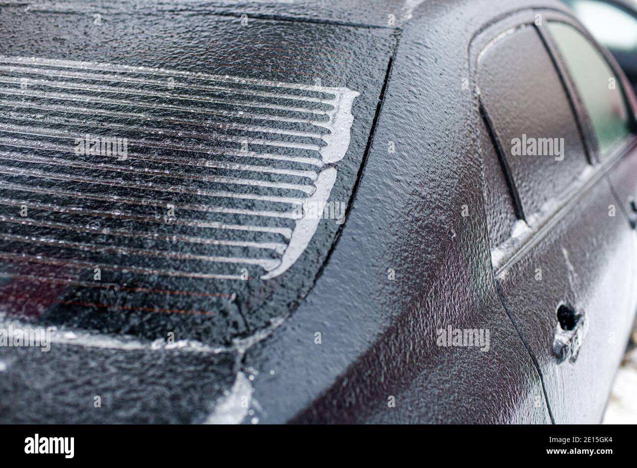 Part of the rear window of a car with heating filaments covered with ...