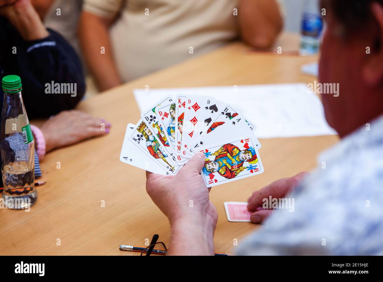 Cropped hands holding playing cards hi-res stock photography and images ...