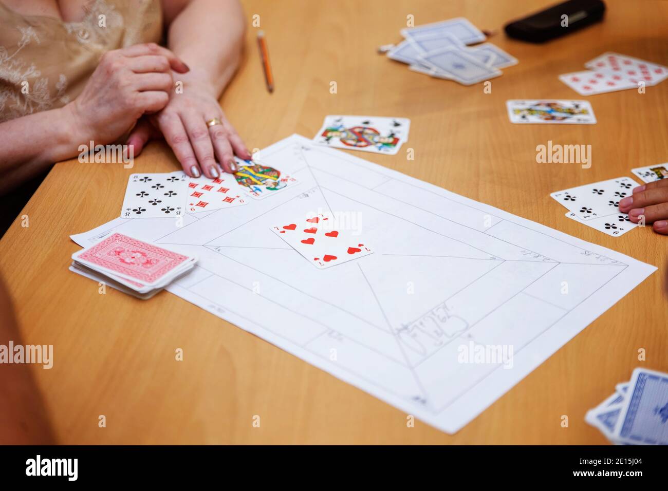 Cropped hands holding playing cards hi-res stock photography and images ...