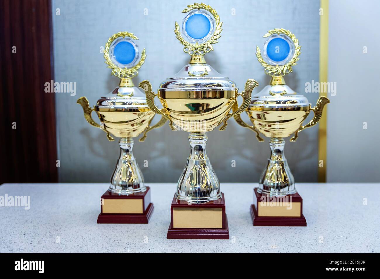 Three cup trophies, gold, silver and bronze Stock Photo - Alamy