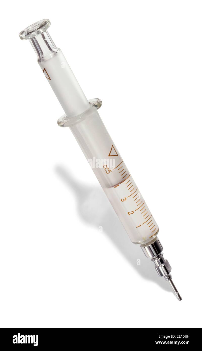 Syringe pointing diagonal to the right photographed on a white ...