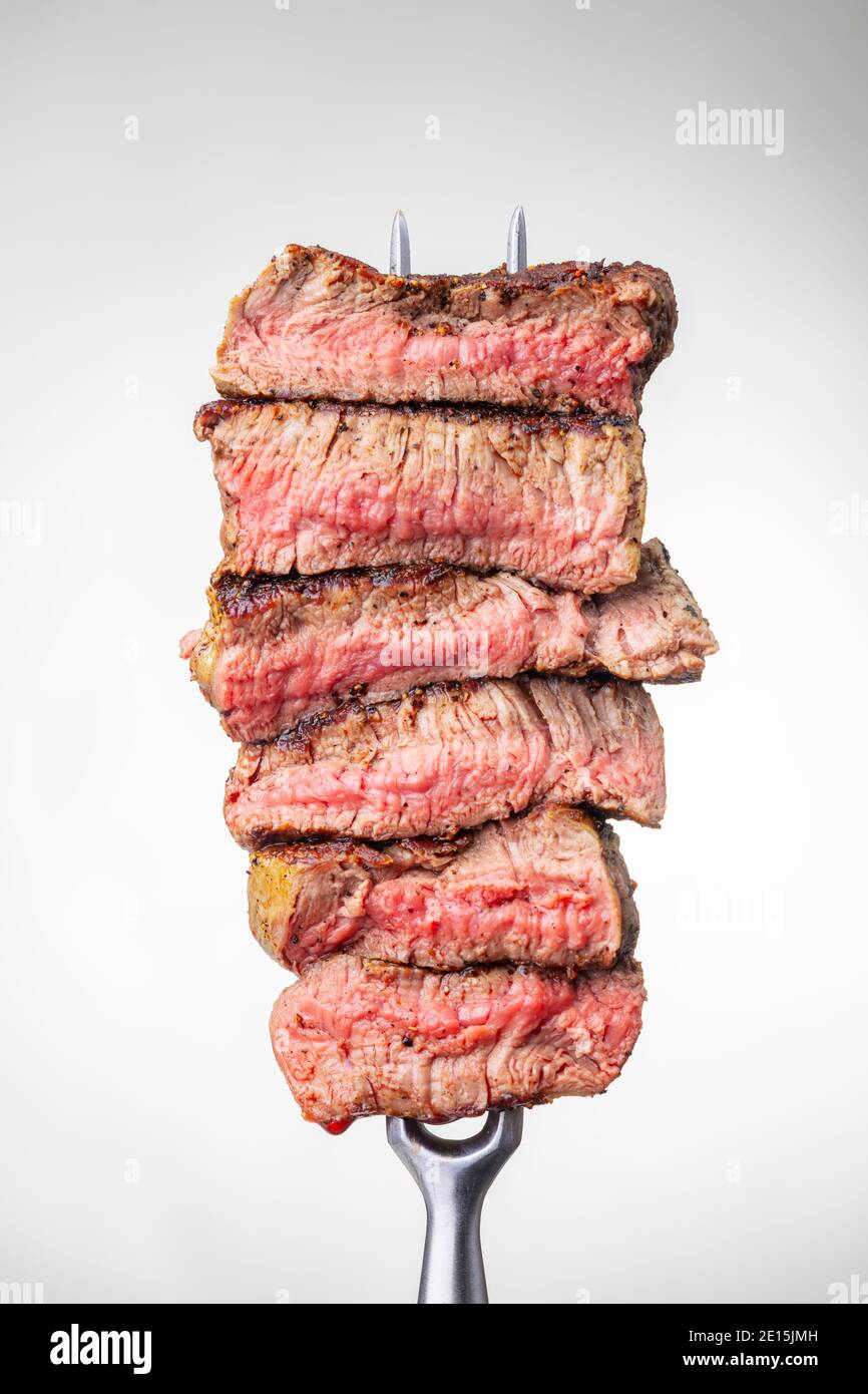 Steak On A Meat Fork Stock Photo - Alamy