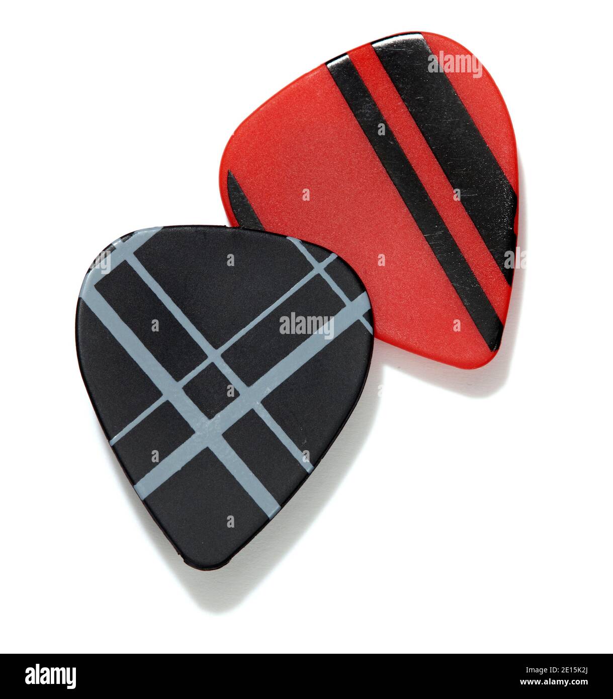 Two black and red guitar picks photographed on a white background Stock ...