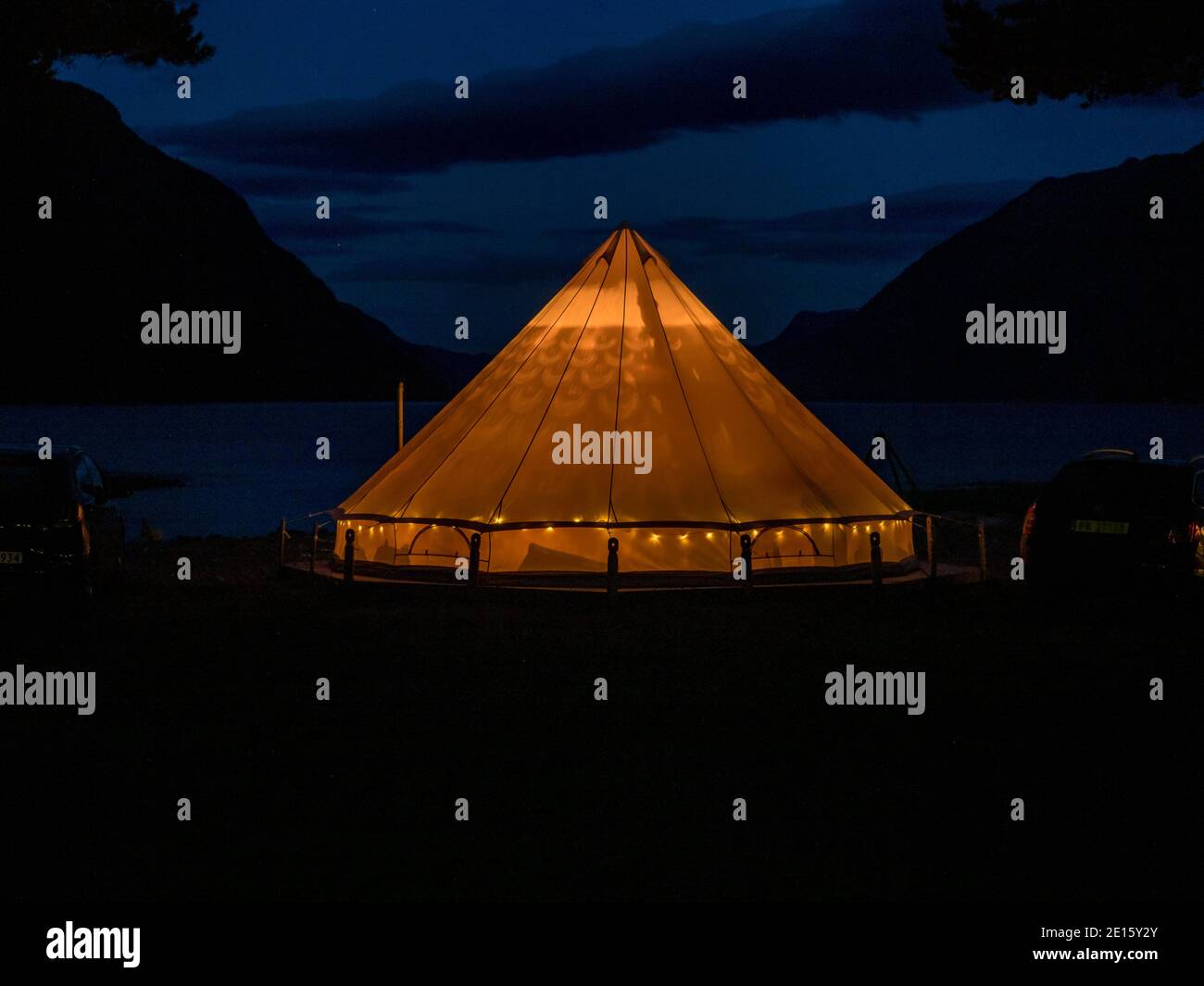 Large luxury tent, illuminated at night, campsite Sandviken at lake ...