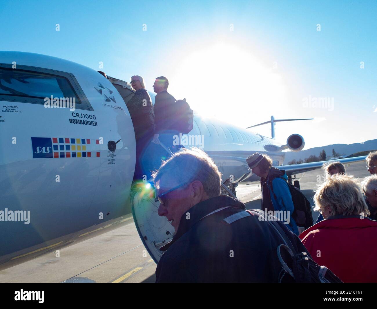 Passengers entering an aircraft Stock Photo - Alamy