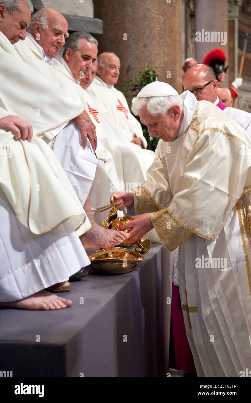 Pope Benedict XVI washes the foot of a priest, during the Holy Thursday ...