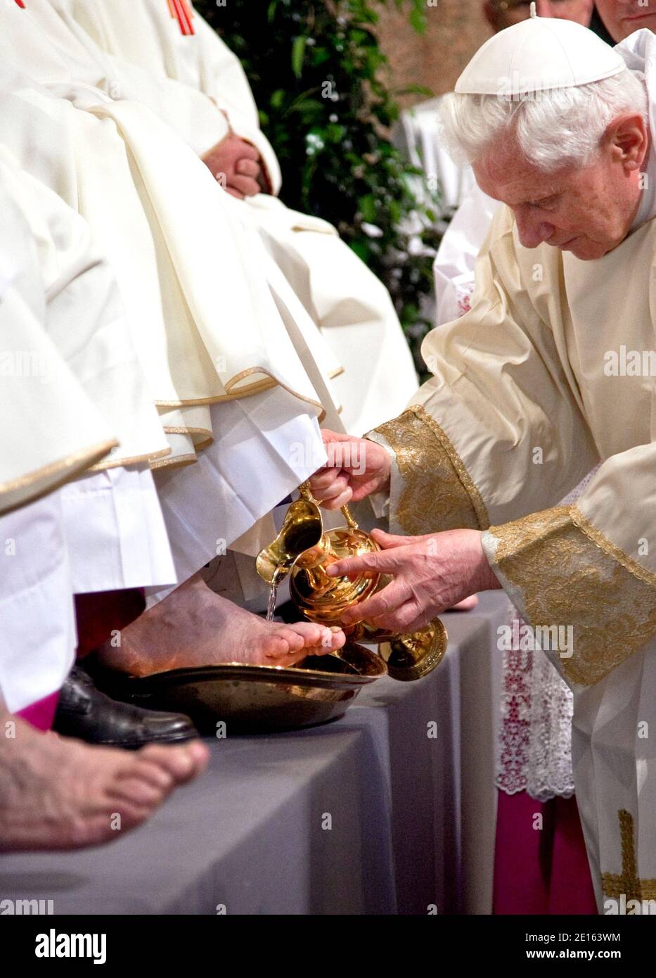 Pope Benedict XVI washes the foot of a priest, during the Holy Thursday ...