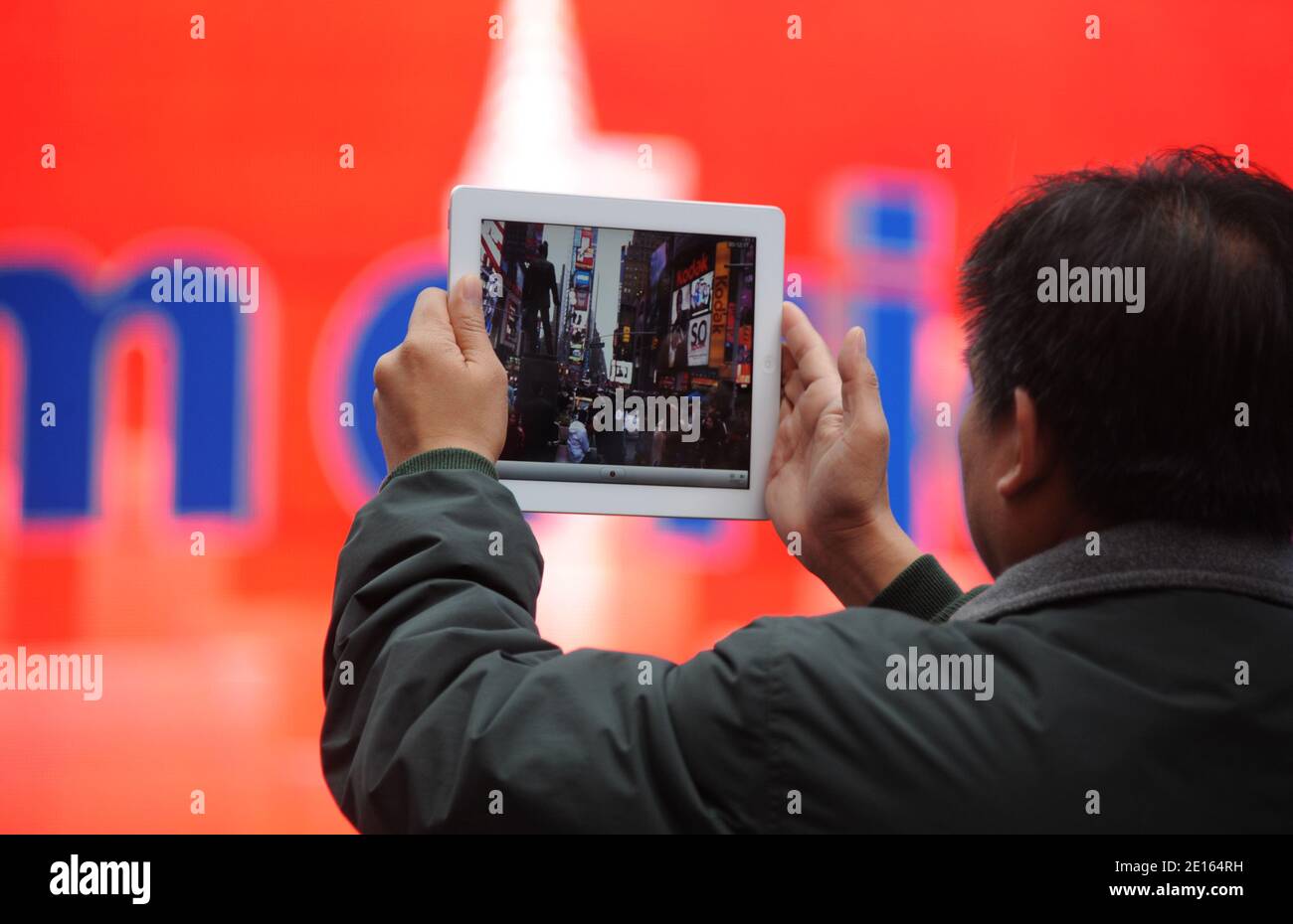 Illustration of a man filming with an iPad 2 in Times Square, New York ...