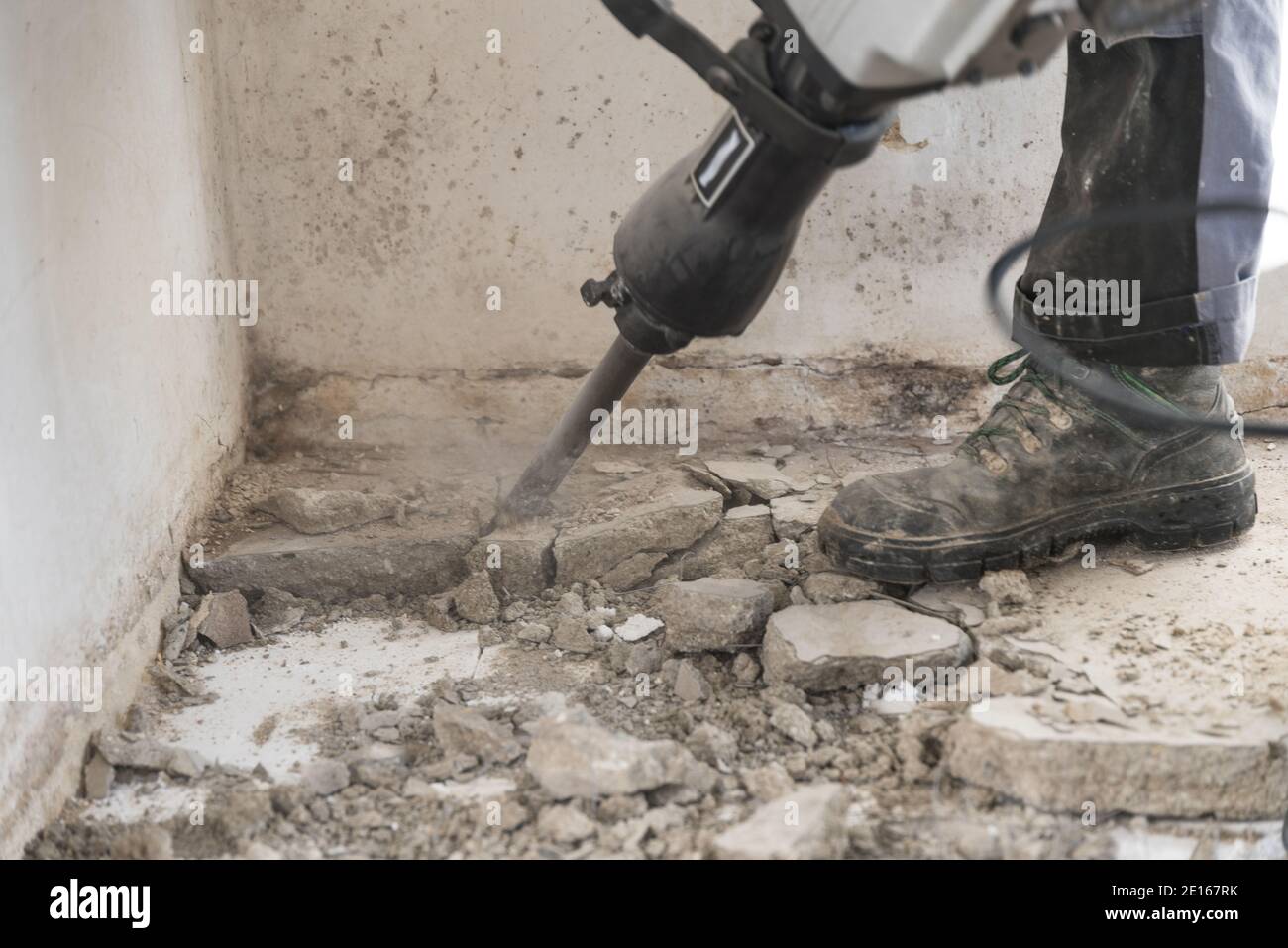 Construction Worker At Construction Site With Demolition Hammer ...