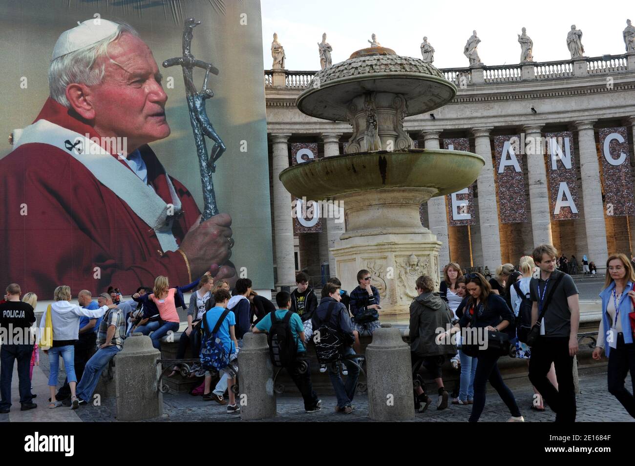 People walk past a giant placard showing picture of late pope John Paul ...