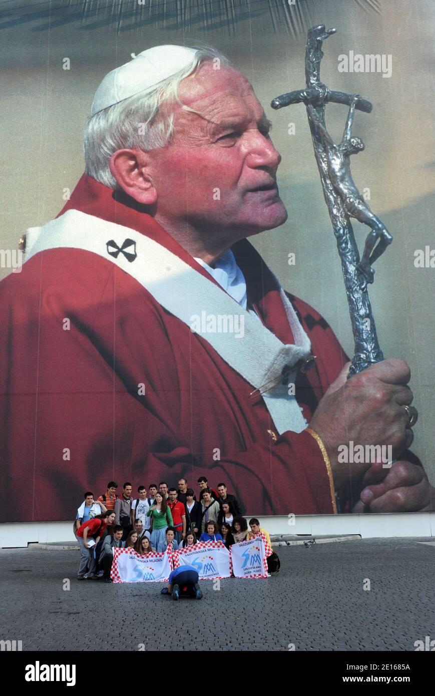 People walk past a giant placard showing picture of late pope John Paul ...