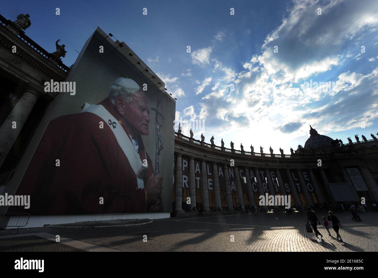 People walk past a giant placard showing picture of late pope John Paul ...
