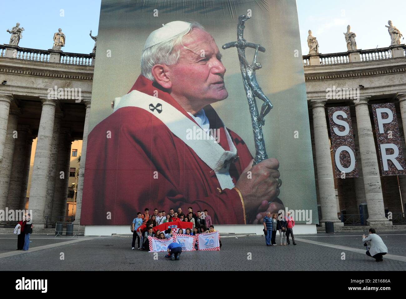 People walk past a giant placard showing picture of late pope John Paul ...