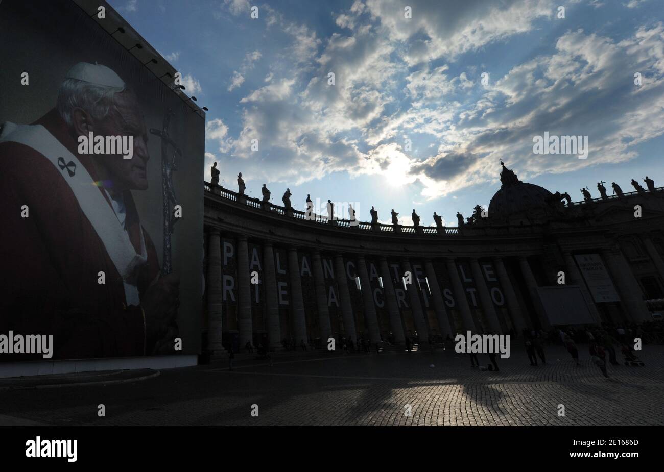 People walk past a giant placard showing picture of late pope John Paul ...