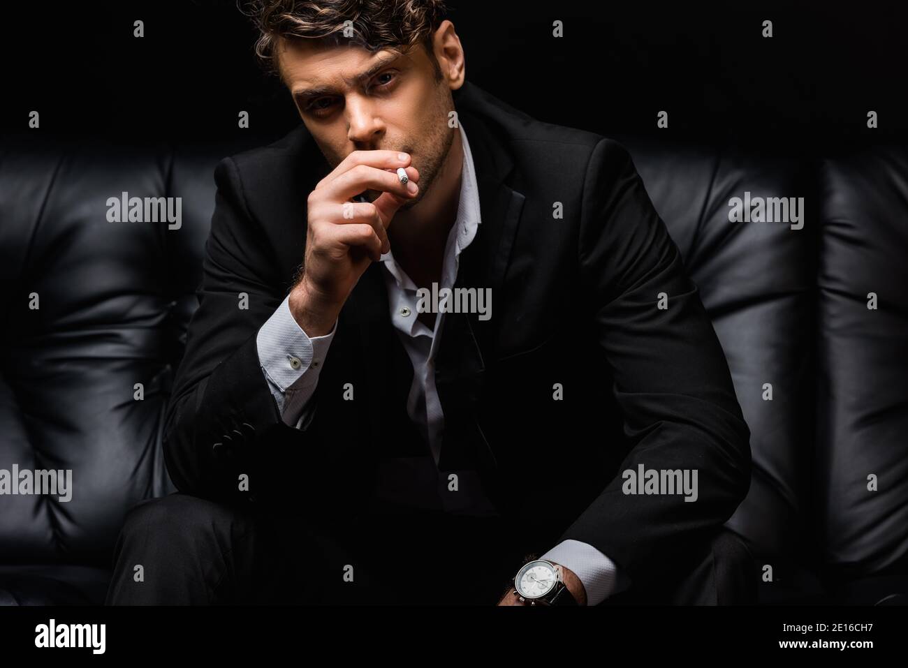 Handsome young man looking cigarette hi-res stock photography and ...