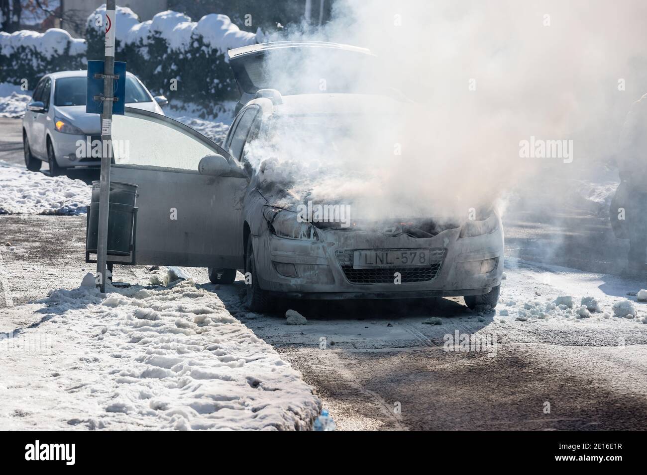PECS, HUNGARY - JANUARY 21: Burning Car on road Pecs in wintertime ...