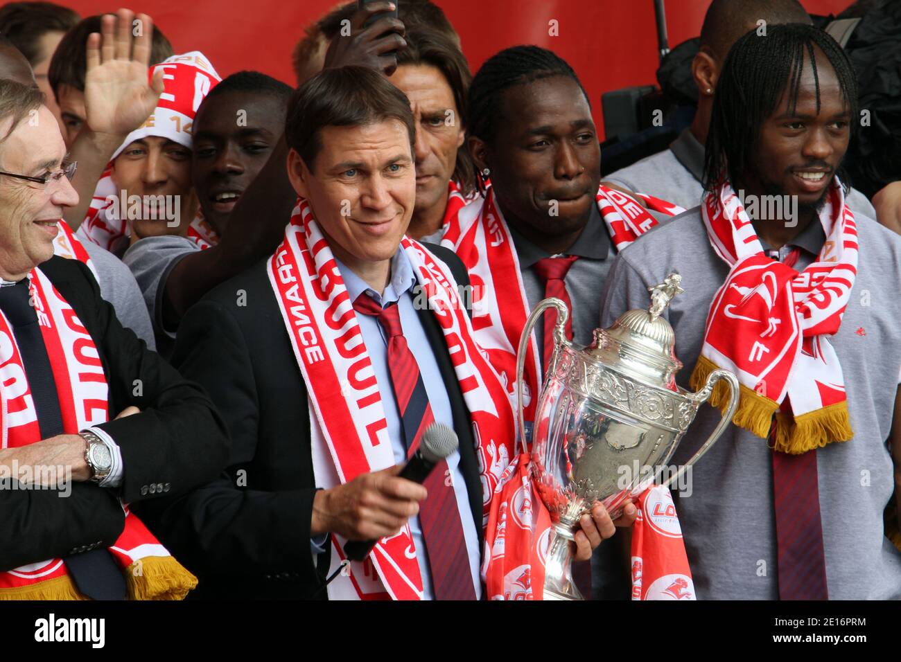 Rudi Garcia waves fans' scarves and sing as they celebrate on a podium ...