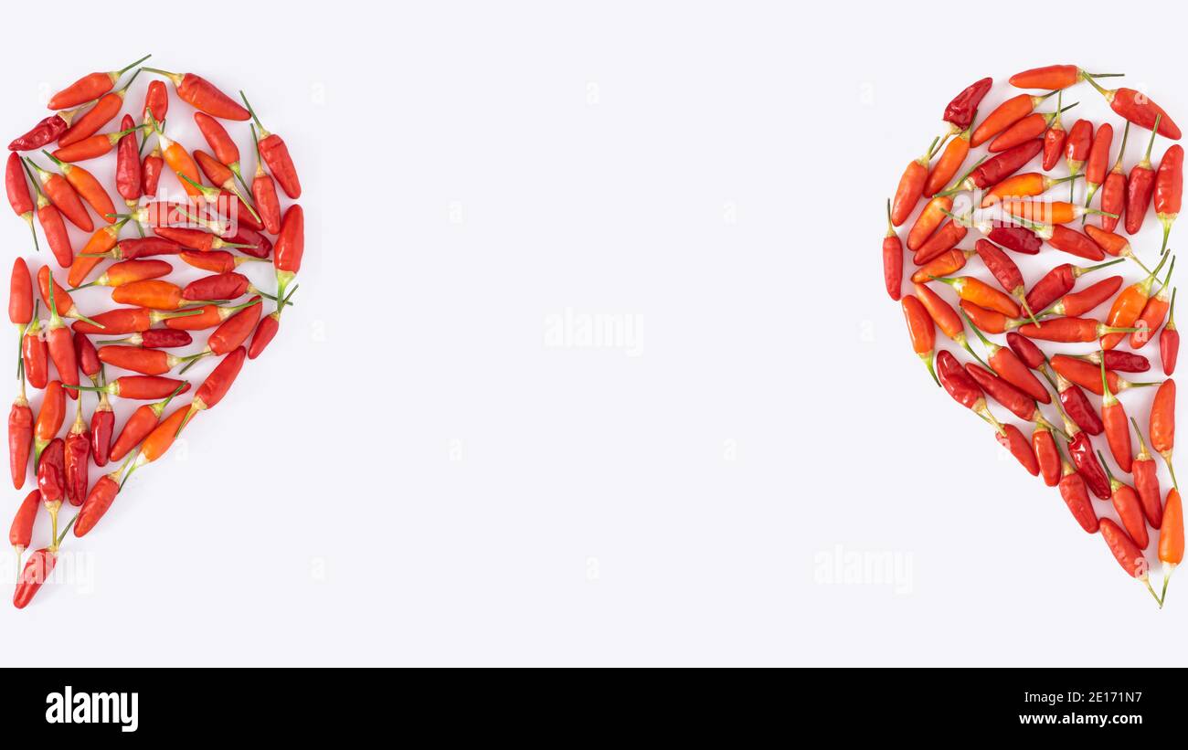Split broken heart from red hot chili peppers on white background Stock ...