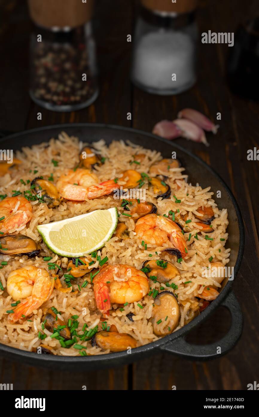 Spanish paella with shellfish and prawns on wooden table, rustic Stock ...
