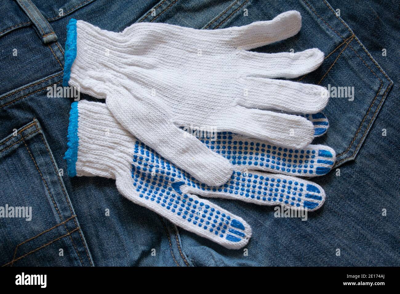 Work gloves white on a denim background Stock Photo - Alamy