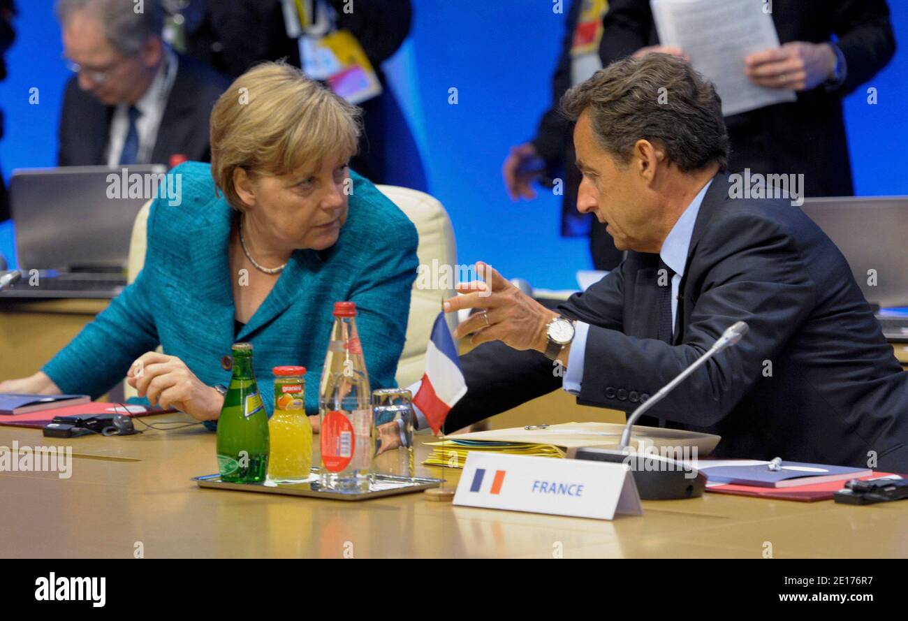 France's President Nicolas Sarkozy talks with German Chancellor Angela ...