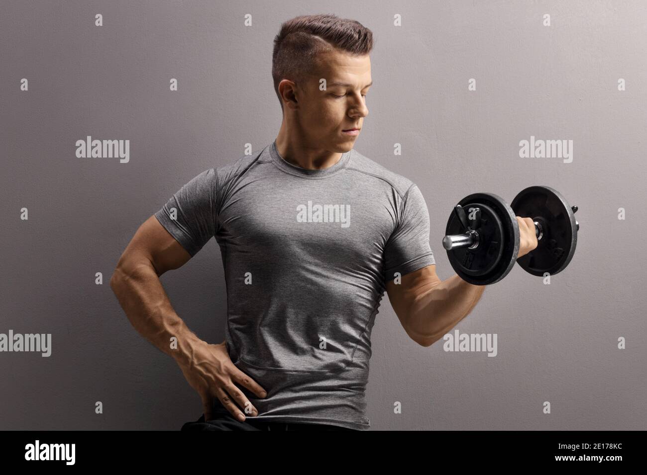 Attractive muscular male bodybuilder leaning hi-res stock photography ...