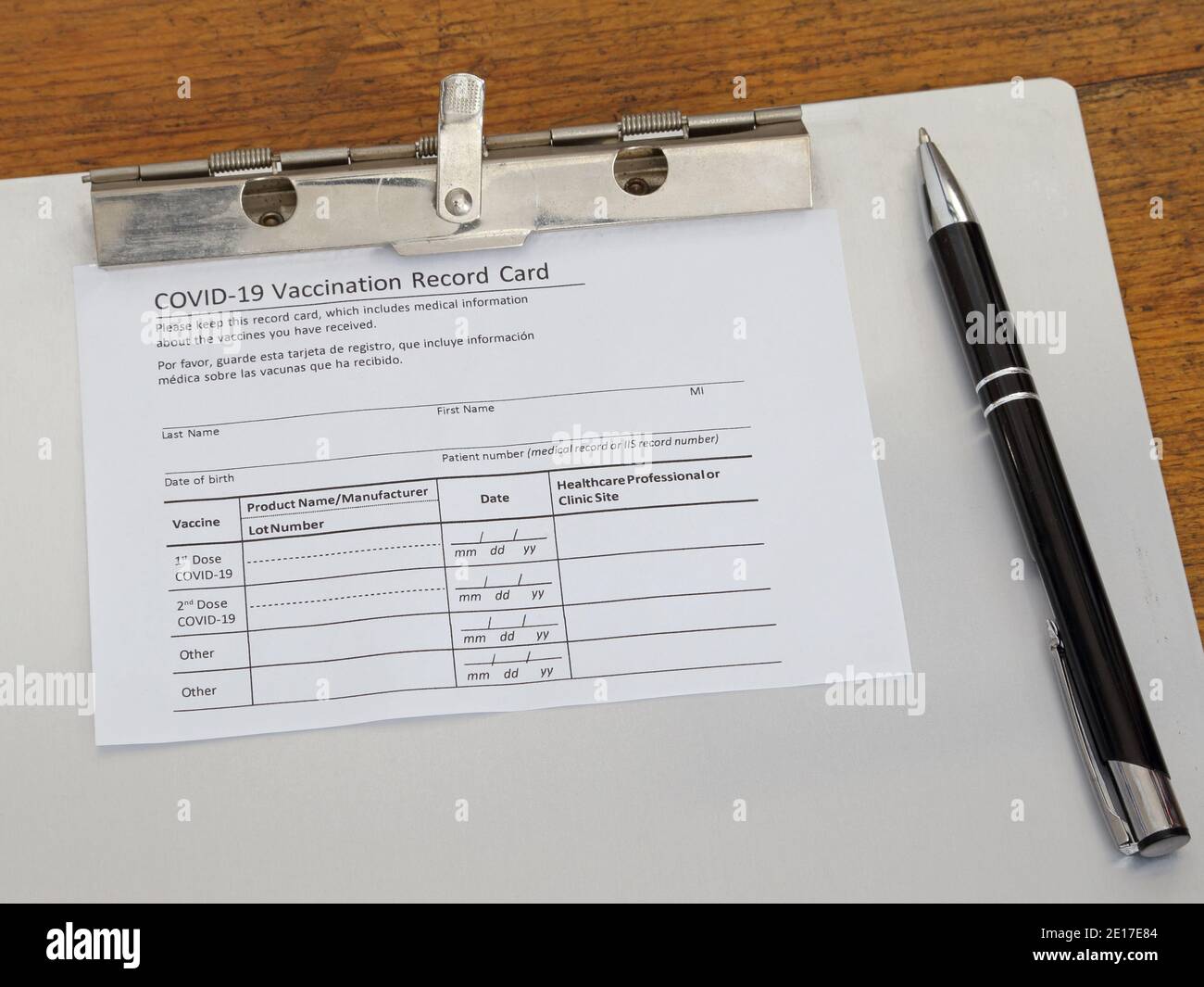 A Coronavirus Covid-19 vaccination record card is shown on an aluminum ...
