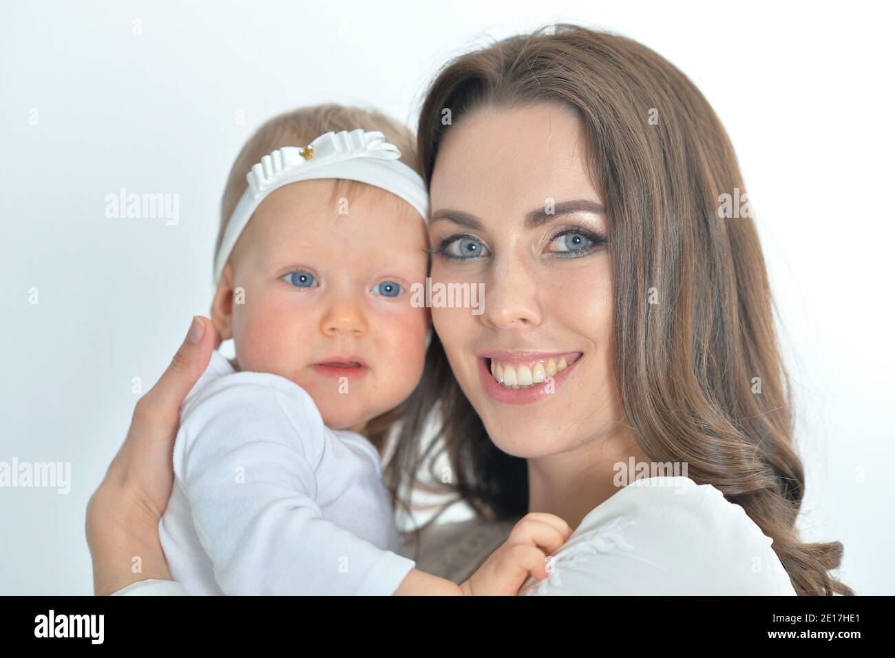 Young mother hugging her cute little daughter Stock Photo - Alamy