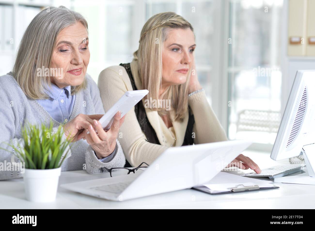 Portrait of two excited mature women working in office Stock Photo - Alamy