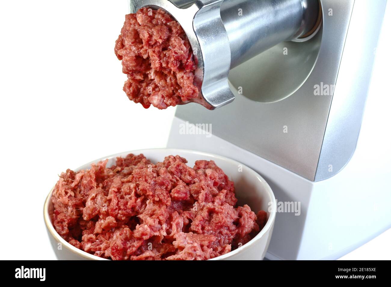 Mincing machine and meat isolated on white background Stock Photo - Alamy