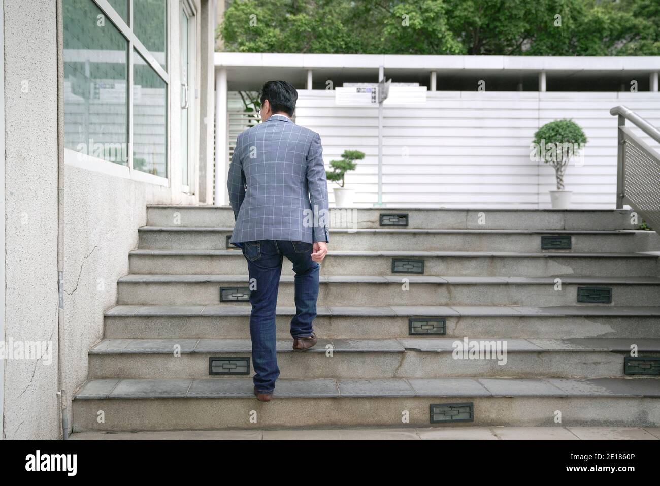 Man climbing stairs rear view hi-res stock photography and images - Alamy