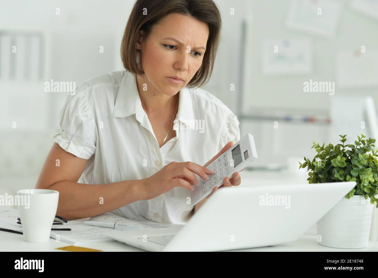 Portrait of a beautiful young woman working Stock Photo - Alamy