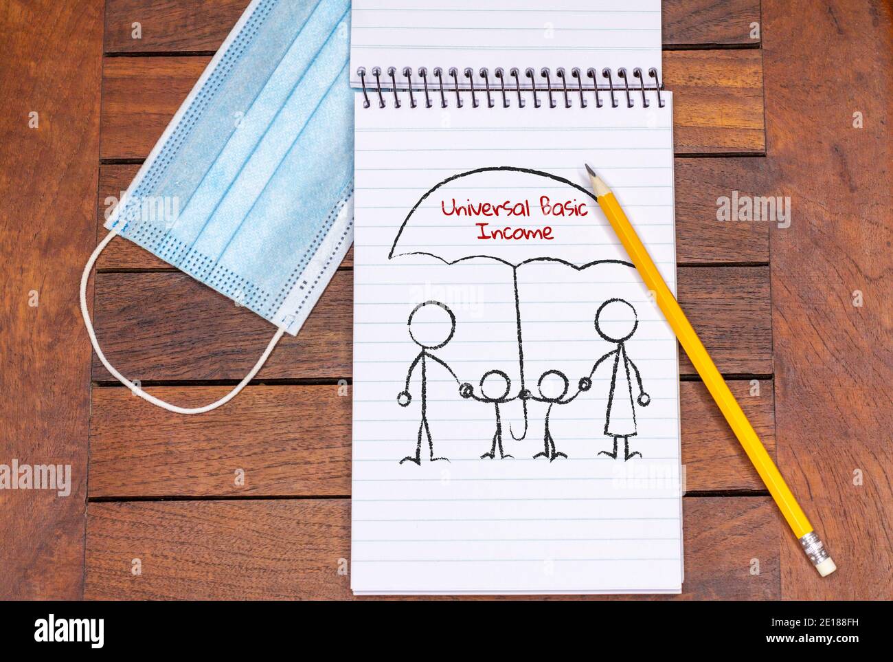 Drawing on note pad of family under the protective umbrella of ...