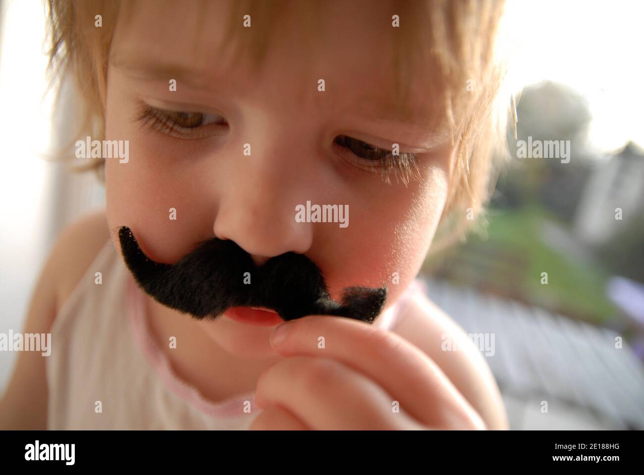A child wearing a false mustache Stock Photo - Alamy