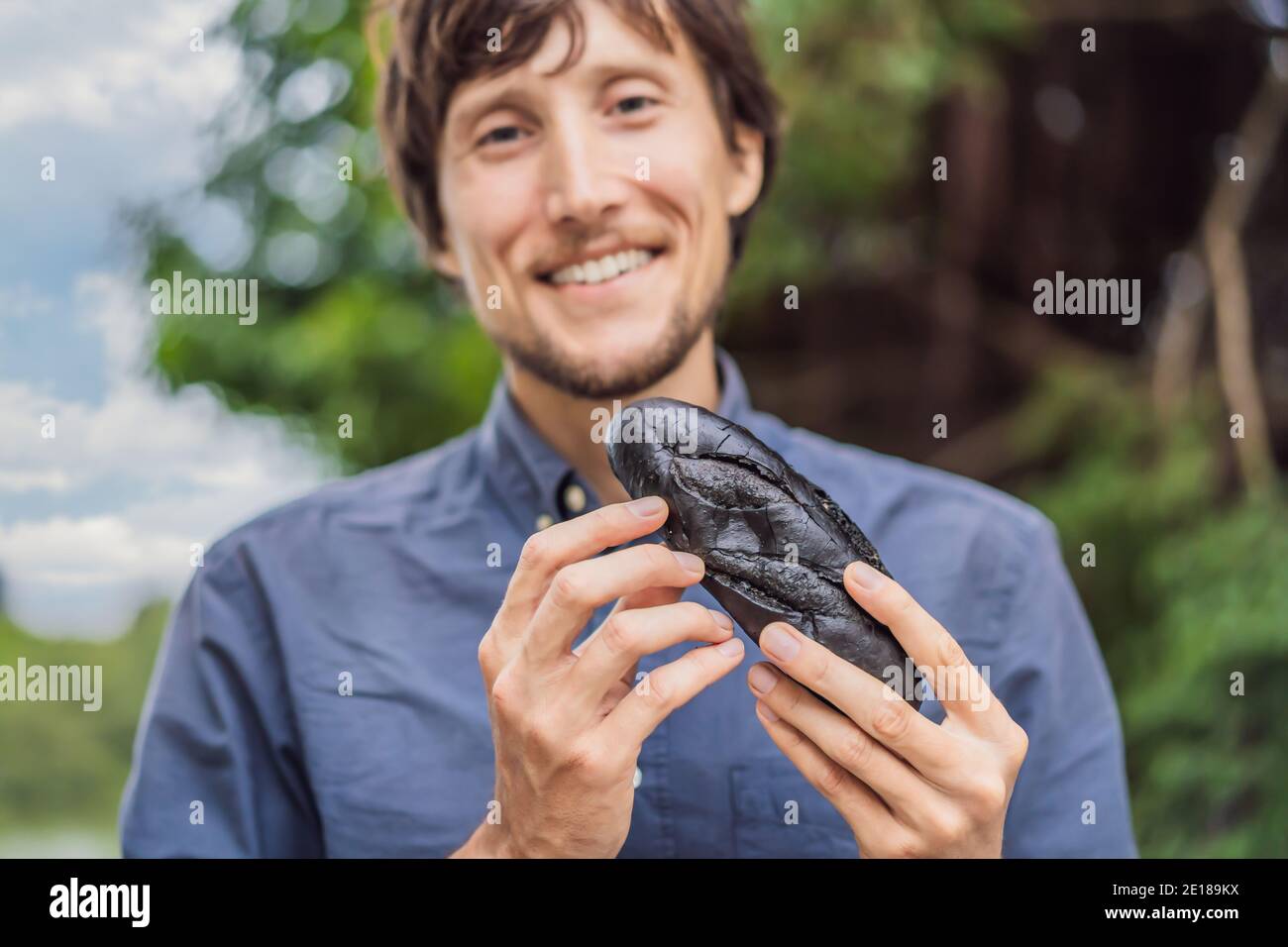 Man eating Vietnamese Pork Banh Mi Sandwich in a black baguette Stock ...